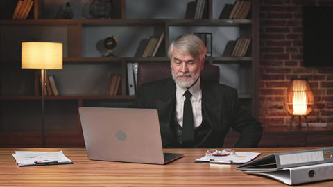 Aged man taking seat behind computer screen in Animated GIF 28209616 ...